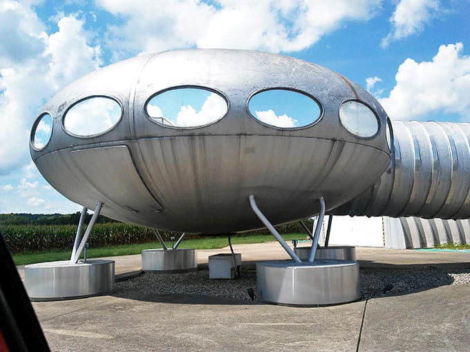 The Futuro's sleek curves and metallic finish capture clouds and sky, turning this stationary structure into a mirror of the heavens above.