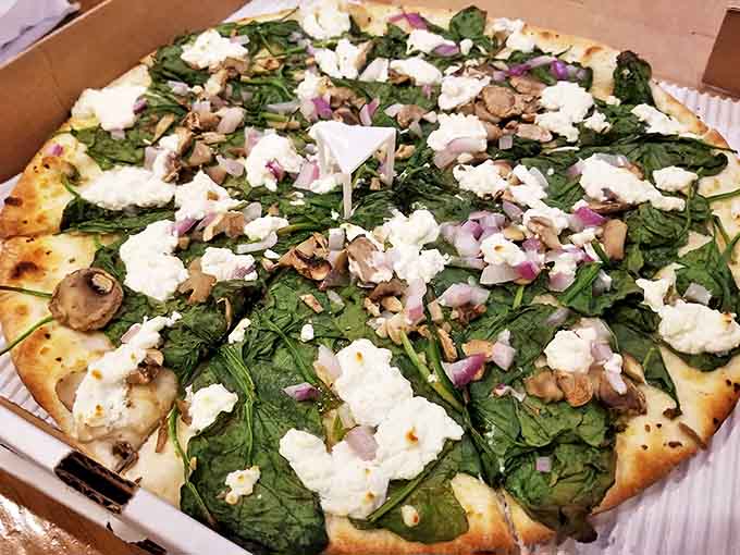 Fresh spinach, tangy feta, and kalamata olives transform this pizza into a Mediterranean vacation for your taste buds &ndash; no passport required.