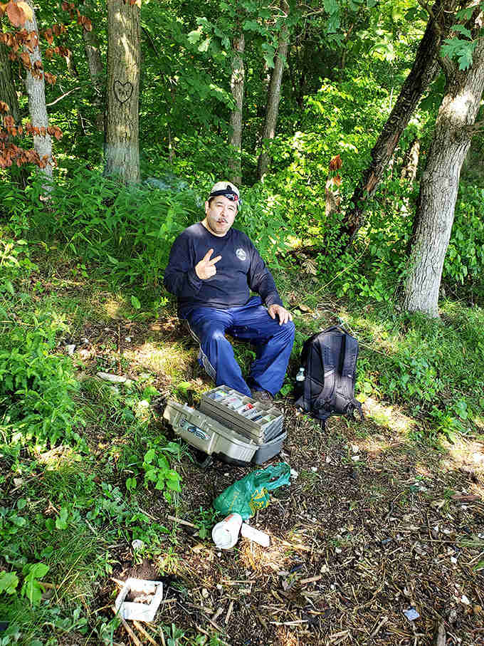 A moment of peaceful communion with nature, surrounded by tackle boxes and the quiet anticipation that comes with waiting for fish to bite.