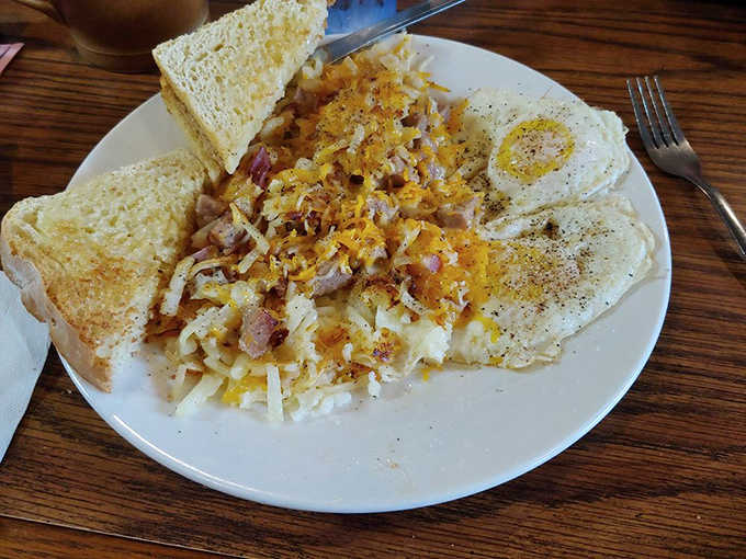 These aren't ordinary hash browns, they're a masterpiece of potato engineering, loaded with ham and cheese that stretches with each forkful.