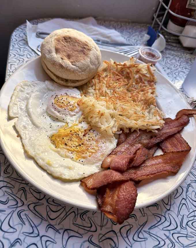 The classic diner breakfast with eggs, hash browns, bacon, and an English muffin never goes out of style.