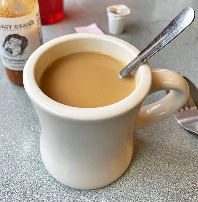 Coffee served in sturdy white mugs &ndash; not fancy, not pretentious, just honest caffeine that looks you straight in the eye and says "Good morning, friend."