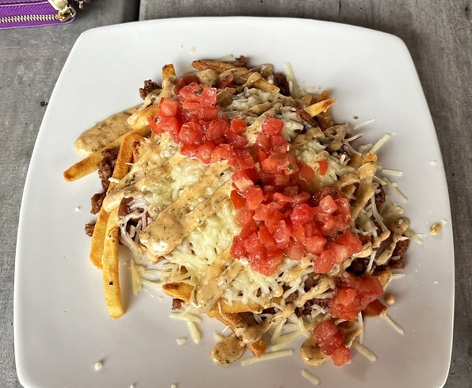 Loaded chili fries that don't discriminate against plant-based eaters. That melty cheese and fresh tomato prove comfort food doesn't need a carnivore's passport.