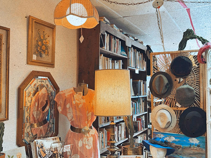 Lampshades cast honeyed light across vinyl records and vintage hats, creating a tableau of perfectly mismatched treasures.