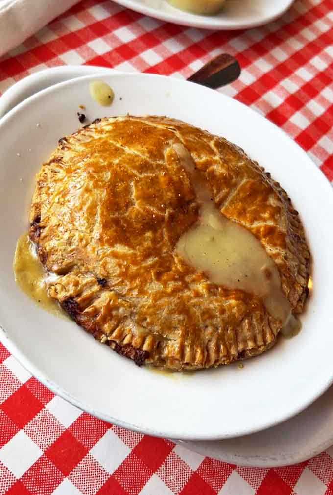 Flaky golden crust gives way to steaming savory filling in this chicken pot pie &ndash; comfort food elevated to an art form.