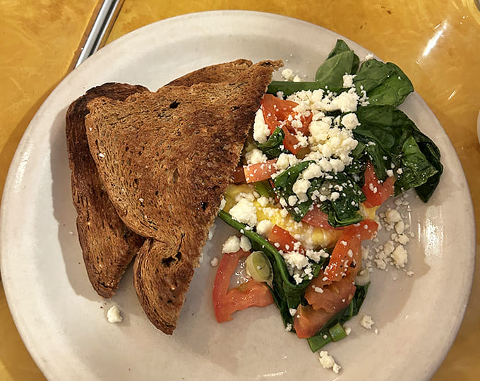 A winter salad offering fresh respite amid heartier fare &ndash; spinach, tomatoes and feta cheese providing Mediterranean-inspired balance.