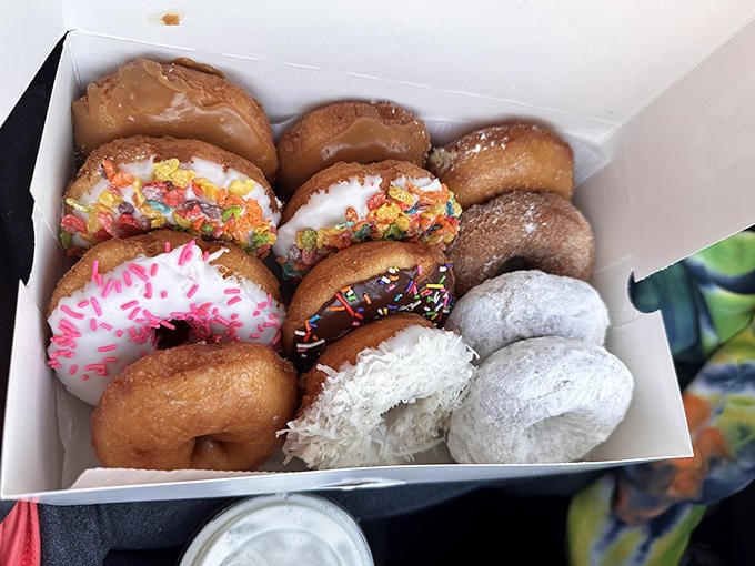 A box of vacation happiness in various forms&mdash;from glazed to sprinkled to coconut-covered&mdash;each one a different path to the same sugar-induced bliss.