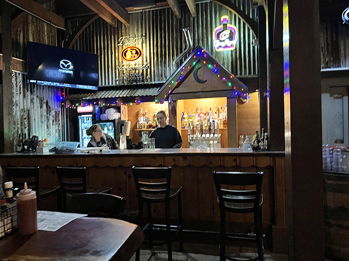 Bar station: The heart of the "Booze" portion of Whitey's promise, where skilled bartenders craft everything from ice-cold beers to classic cocktails under twinkling lights.