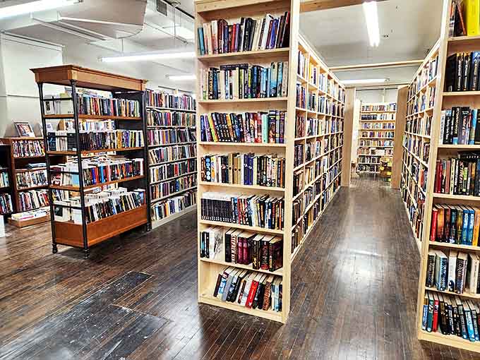 Wooden shelves stretch from floor to ceiling, creating narrow passageways that feel like navigating the corridors of a literary spaceship.