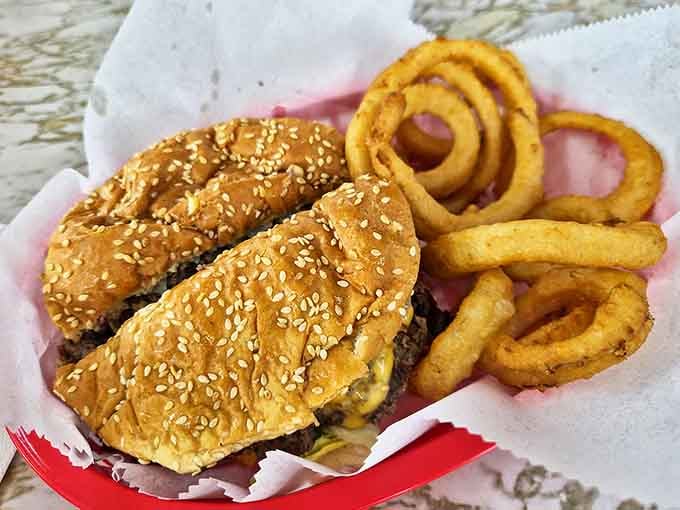 Onion rings that maintain their structural integrity paired with a burger that demands both hands and several napkins.