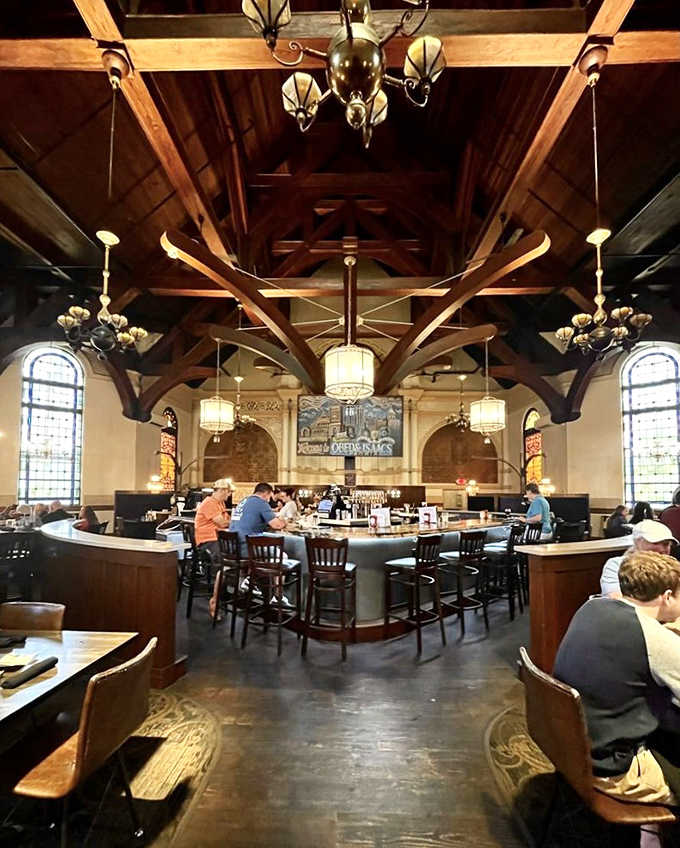 The circular bar serves as the new pulpit from which liquid sermons are delivered, beneath wooden beams arching like the ribcage of a magnificent beast.