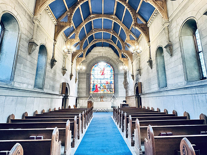 Sunlight streams through stained glass in this breathtaking chapel, where blue ceiling vaults create heavenly atmosphere.