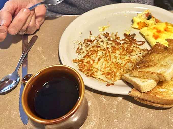That first sip of diner coffee—strong, hot, and served in a sturdy mug—the perfect companion to hash browns and toast as morning light streams in.