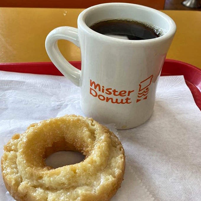 That perfect pairing: strong, honest coffee in the iconic Mister Donut mug alongside a fresh-from-the-fryer classic – breakfast of champions.