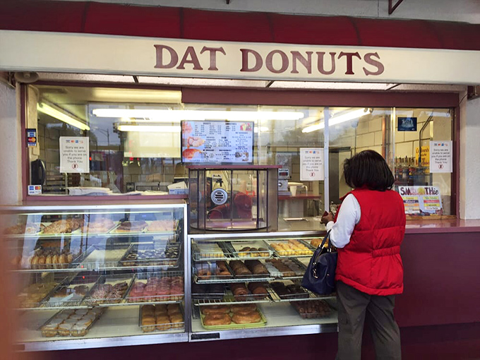 The look of pure concentration before tackling these massive pastries requires strategy and determination.