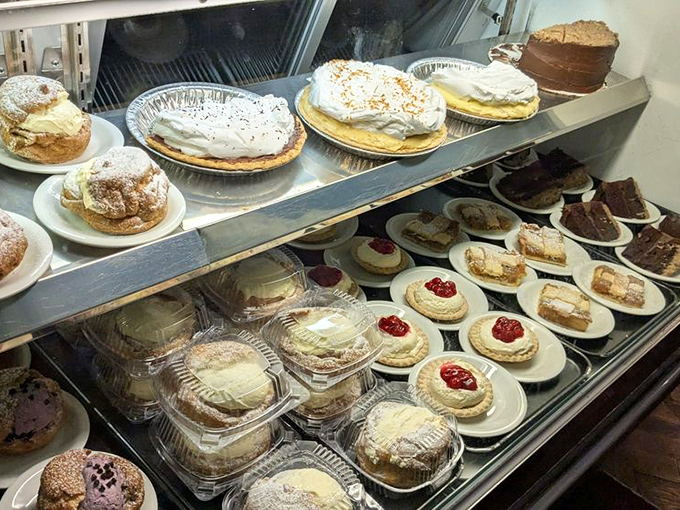 The dessert case at Schmidt's is basically a museum of sweet German engineering, where cream puffs and strudels compete for your attention.