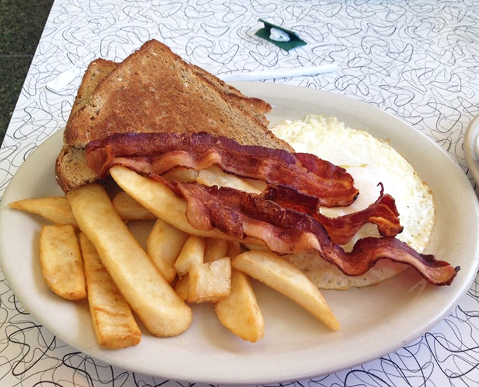 The breakfast special features perfectly cooked eggs, crispy bacon, and golden toast &ndash; simple morning perfection executed with care.