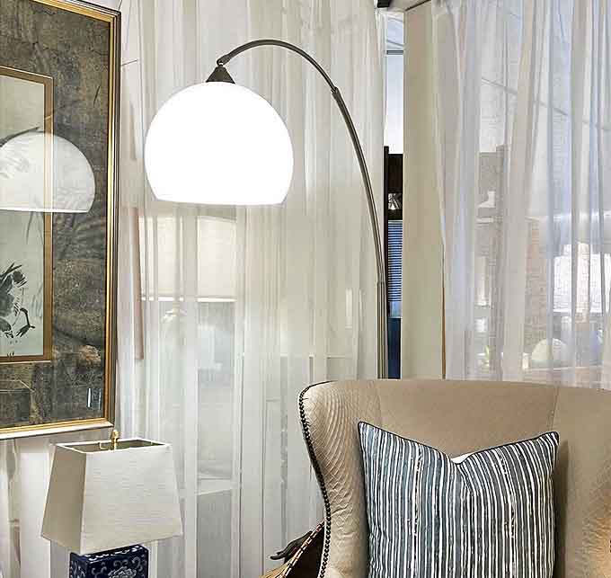 A perfectly positioned floor lamp creates a reading nook anywhere, turning that neglected corner into your new favorite escape.