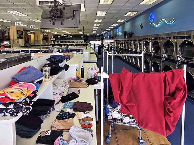 The folding station battlefield where wrinkled chaos transforms into orderly stacks of domestic victory.