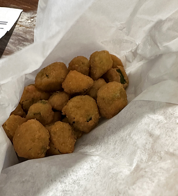 Simple pleasures done right – fried okra nuggets that convert even the most skeptical into true believers with their crispy, seasoned goodness.
