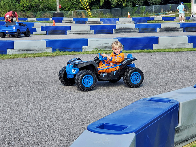 Pure joy radiates from this young driver, discovering the thrill of controlling his own vehicle on the specially designed kids' track.