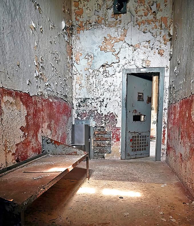 A solitary cell where punishment meant complete isolation &ndash; the rusted bed frame and peeling walls speak volumes about psychological torment.