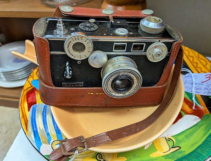 This vintage camera once captured someone's precious memories on film, a mechanical marvel from when photography required patience and skill.