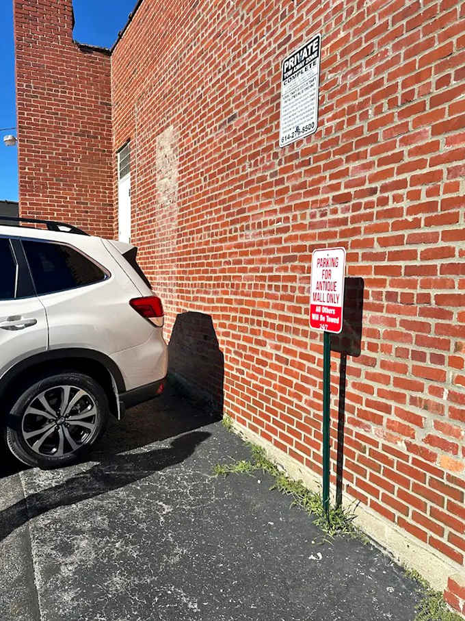 Even the parking area maintains that vintage charm &ndash; a reminder that treasures await just beyond that brick wall.
