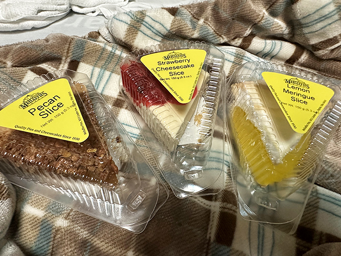 The holy trinity of pie slices &ndash; pecan, strawberry cheesecake, and lemon meringue &ndash; arranged like edible playing cards in a game everyone wins.