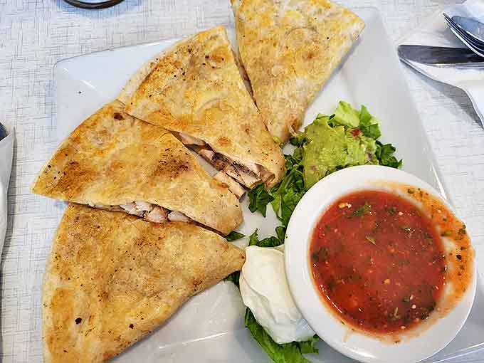 Crispy quesadillas served with the holy trinity of toppings &ndash; fresh salsa, cool sour cream, and guacamole that was definitely worth the extra charge.