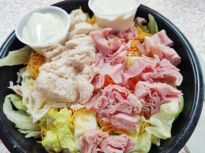 A garden of freshness amid comfort food indulgence &ndash; crisp lettuce cradles tender turkey and ham in a protein-packed flavor festival.