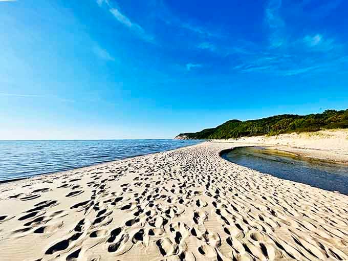Sandy shores curve gently along the coastline, creating natural coves where visitors can find their own private spot.