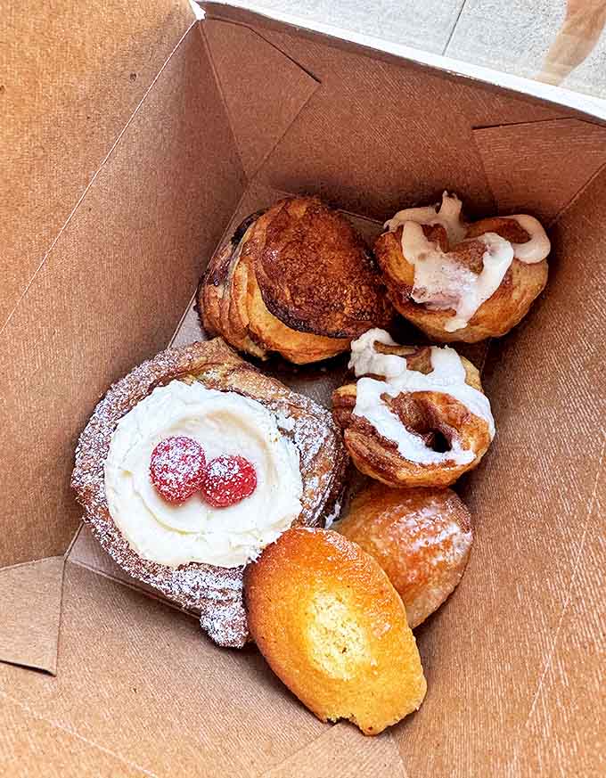 A box of happiness to go! These assorted pastries promise moments of pure joy with every flaky, buttery, cream-filled bite.