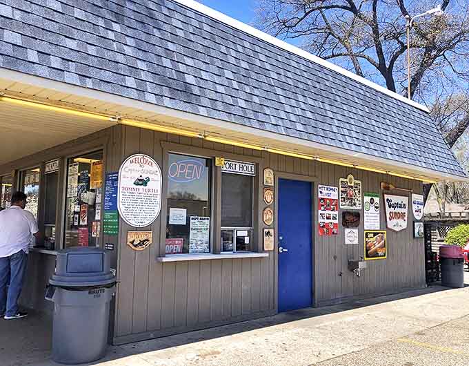 Captain Sundae's humble gray building with blue trim has been serving Holland's ice cream needs for generations. The simple walk-up windows create a nostalgic summer experience.
