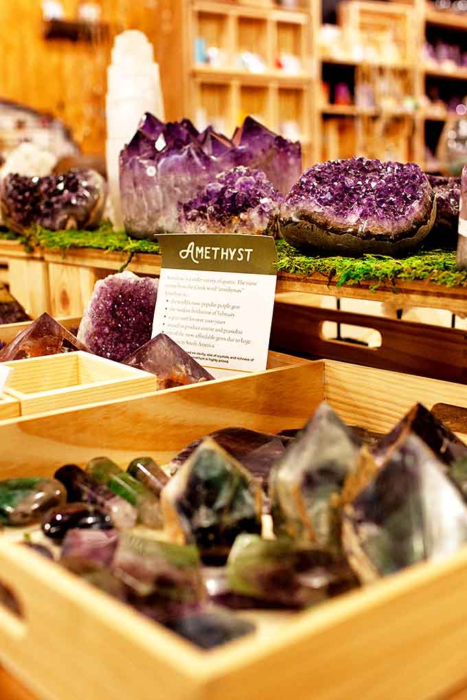 Amethyst crystals catch the light like frozen purple flames, showcasing nature's ability to create beauty in complete darkness.