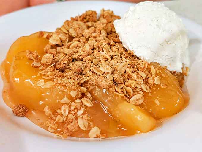The warm apple crisp bubbles with cinnamon-spiced goodness under a melting scoop of vanilla ice cream. Grandma would be proud.