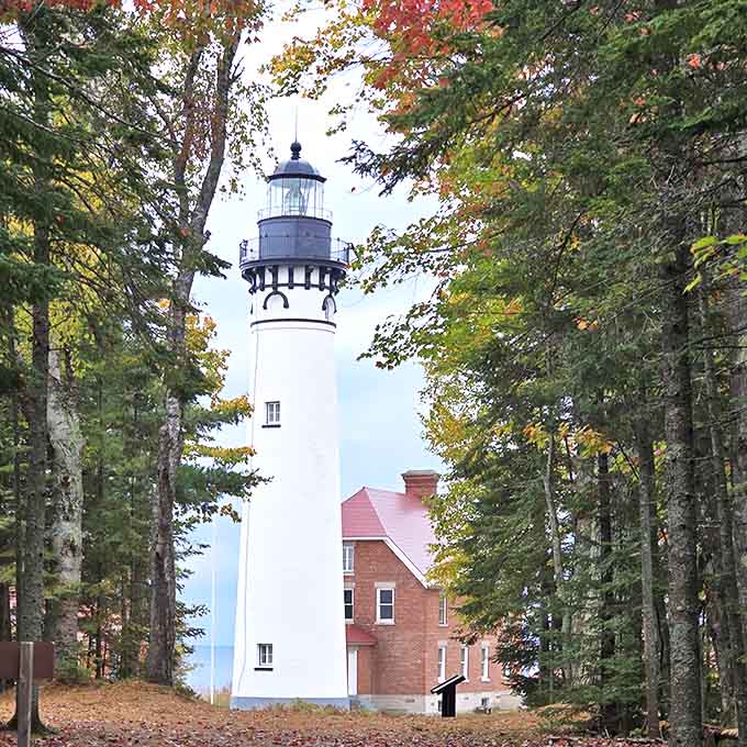 Au Sable Light Station stands tall against Michigan's moody skies, a reminder of when navigation required more than just asking Siri.
