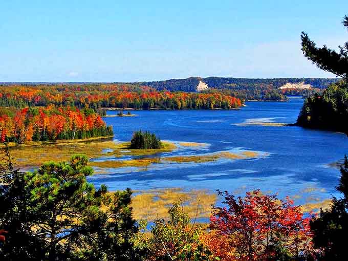 Autumn transforms the landscape into a painter's palette, with Lake Huron's blue waters providing the perfect contrast to the fiery forest canopy.