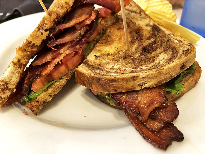 This isn't just a sandwich; it's a skyscraper of crispy bacon, garden-fresh tomatoes, and lettuce on perfectly toasted bread.