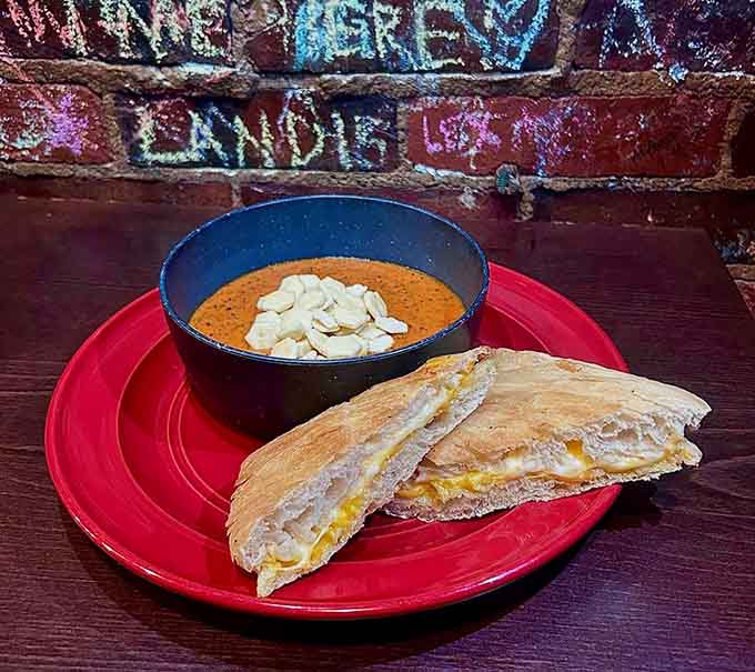 Creamy tomato basil soup meets its perfect partner in a grilled cheese that elevates comfort food to art.