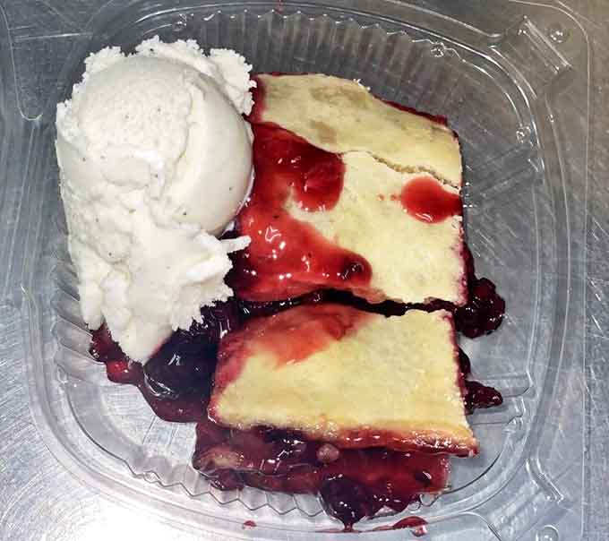 Blackberry cobbler with ice cream: where fruit and buttery crust meet cold creaminess in a dessert that demands you save room.