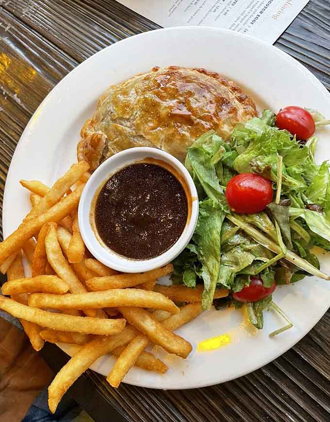 Cornish pasty with a flaky golden crust that would make any British grandmother nod approvingly at its proper execution.