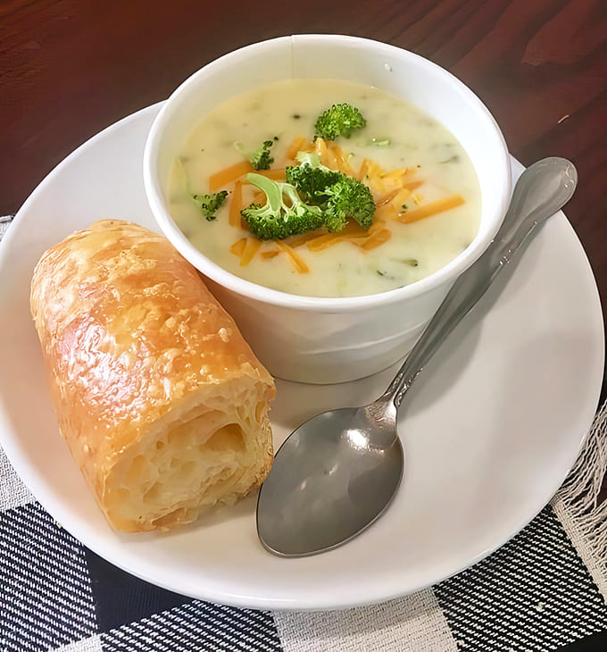 Broccoli cheddar soup served with a buttery croissant makes eating your vegetables feel less like a chore and more like a reward you actually want.