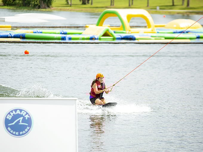 Learning the ropes: A determined wakeboarder gets pulled across the lake's surface, discovering that falling is just part of the journey to mastery.