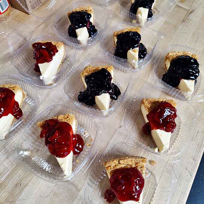 Cheesecake slices topped with vibrant fruit compote &ndash; little wedges of heaven that make Monday feel like Saturday with every bite.