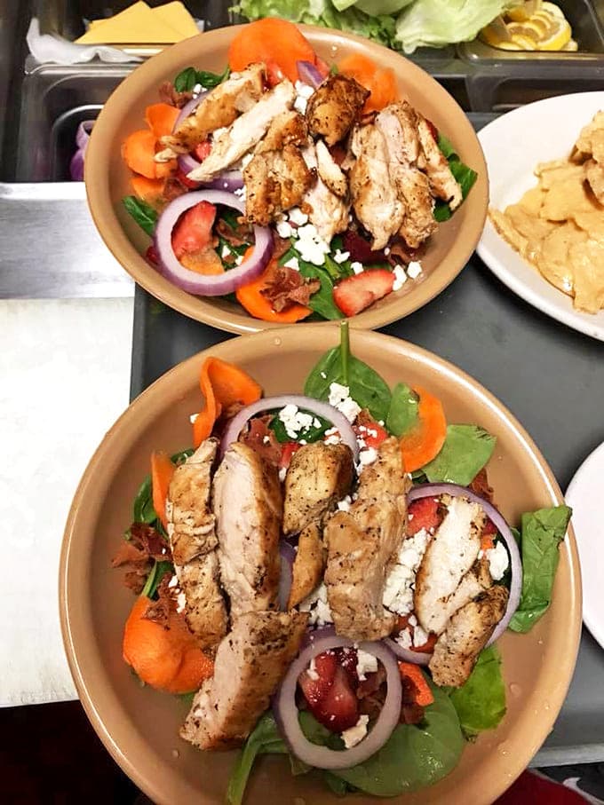 Grilled perfection fanned across fresh greens with vibrant vegetables and crumbled cheese. Proof that "healthy" and "delicious" aren't mutually exclusive concepts.