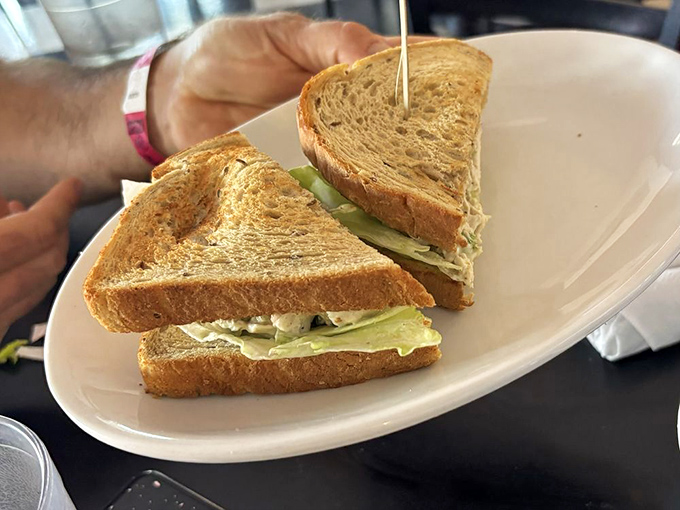 A chicken salad sandwich that doesn't skimp on the good stuff, served with a side of nostalgia and crisp lettuce that actually tastes fresh.