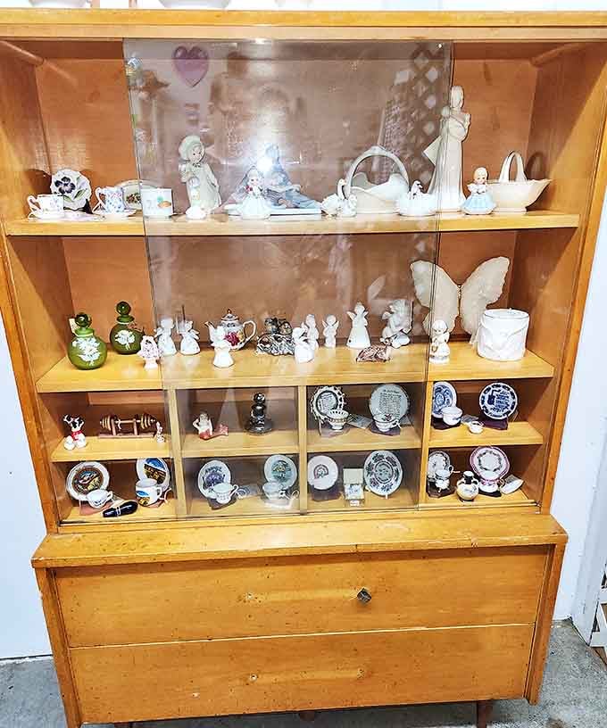 This china cabinet displays delicate treasures that survived decades of family dinners, holiday gatherings, and careful dusting.