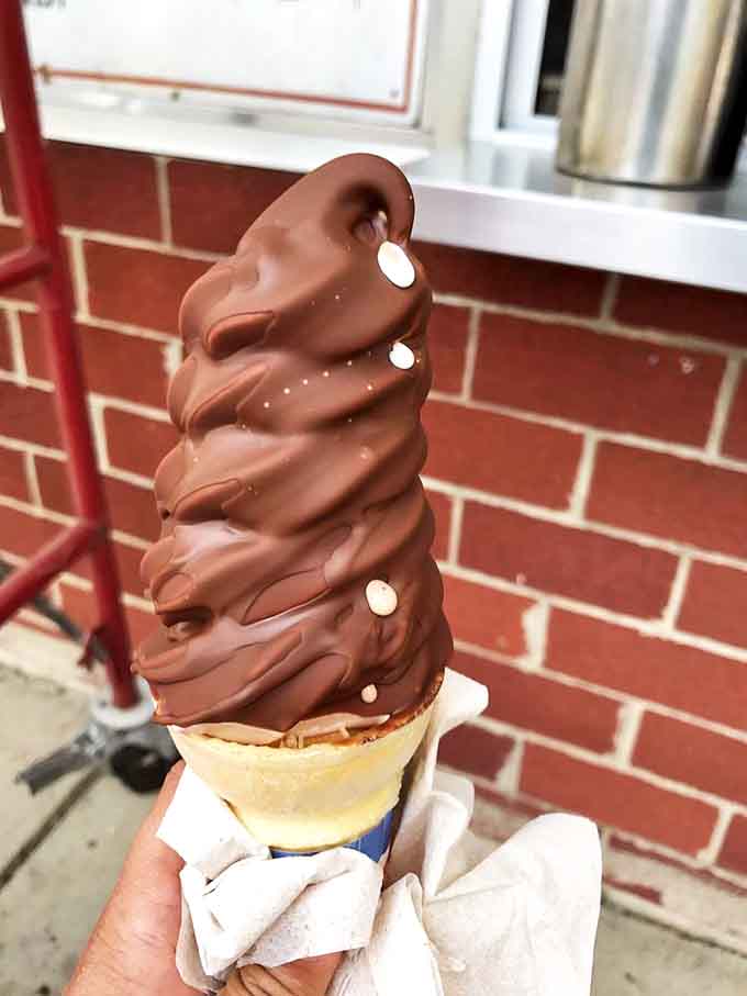 The chocolate-dipped cone stands tall and proud, a monument to simple pleasures that somehow never gets old.