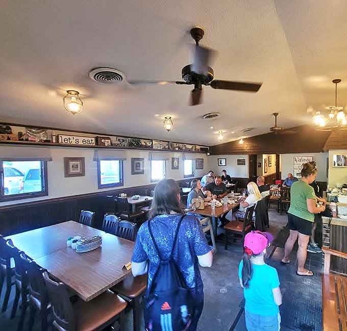 The dining area buzzes with conversation and laughter as families and friends gather around tables to share not just pizza, but moments.